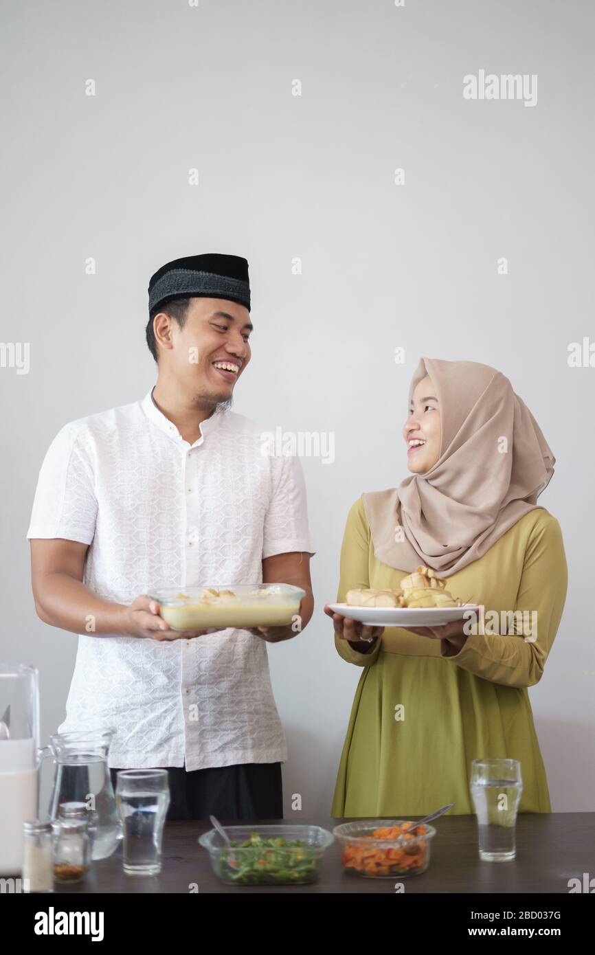 muslim family breaking the fast on ramadan kareem. islam dinner after ...