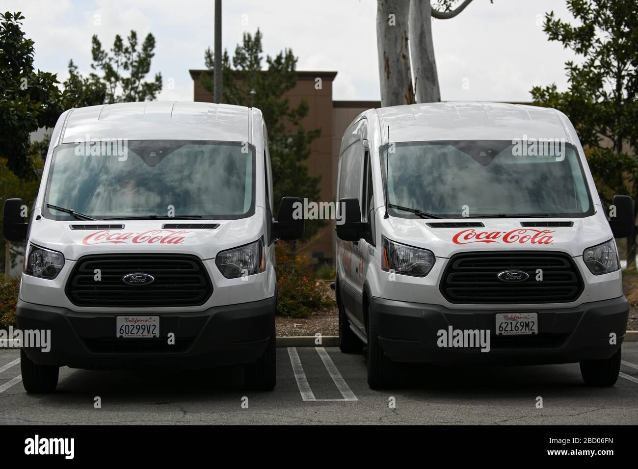 Vans branded with Coca-Cola logos sit outside a Coca-Cola Bottling ...