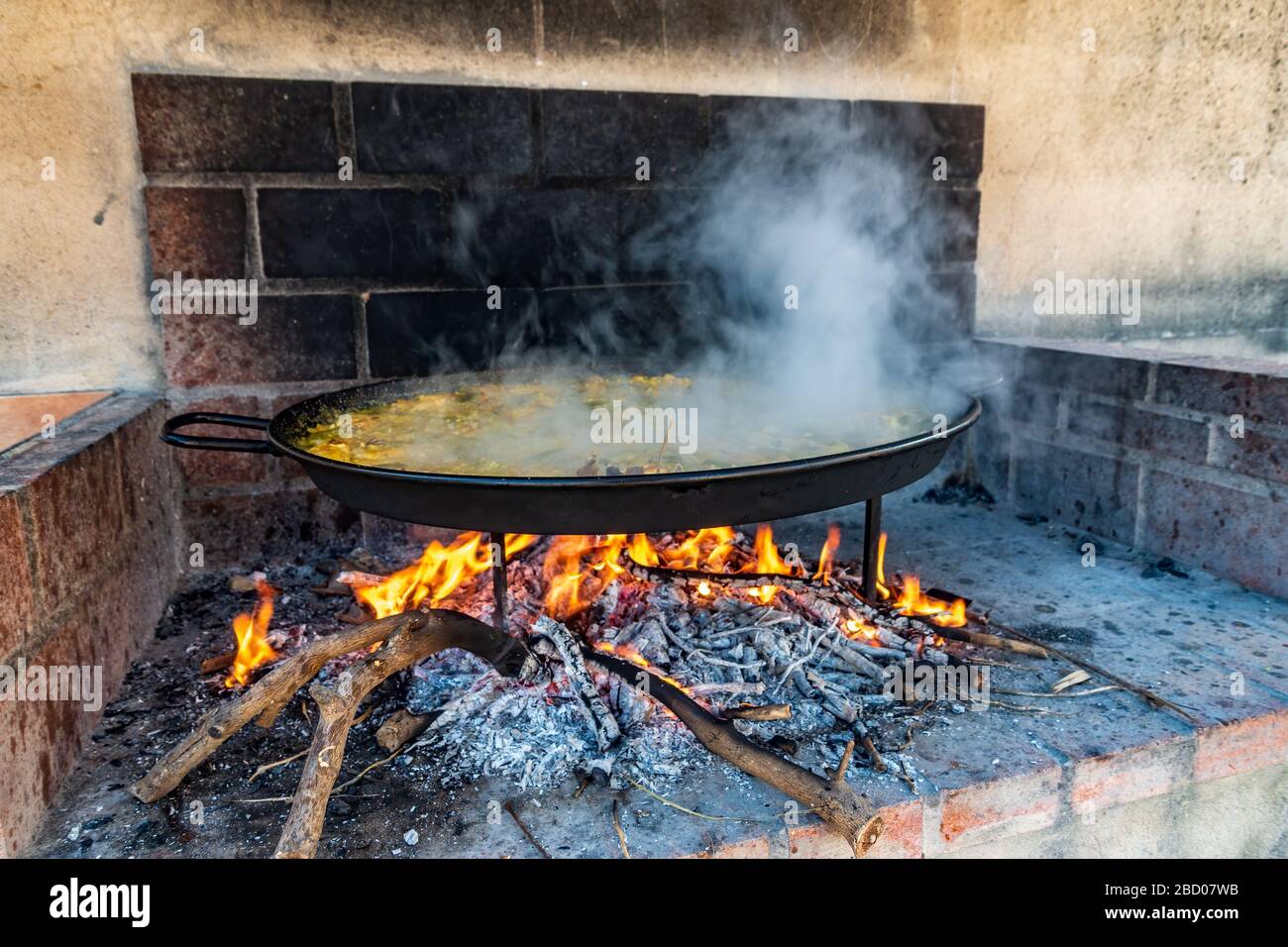 Preparing typical spanish paella in the fire Stock Photo - Alamy