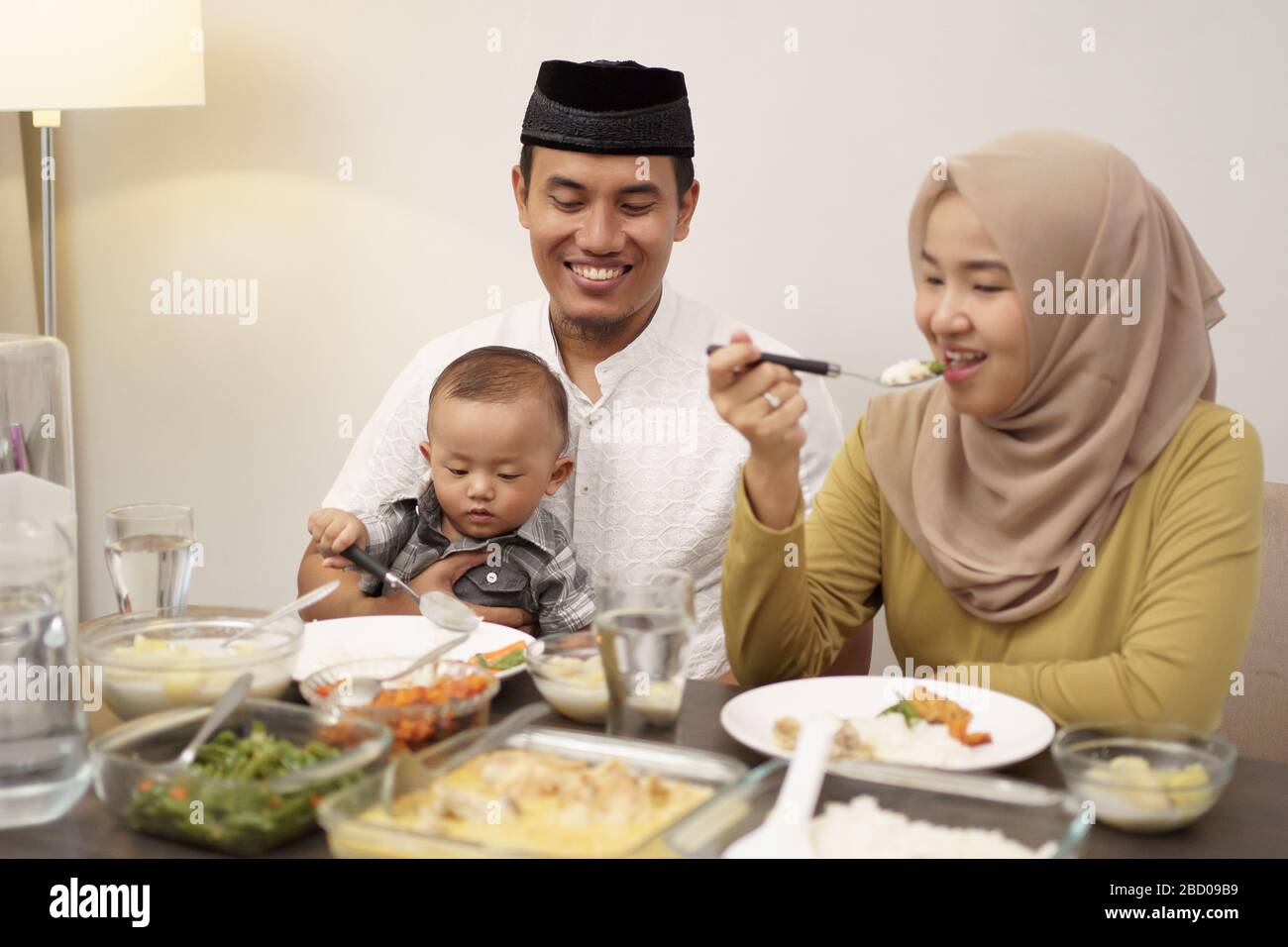 Muslim family having breakfast at home hi-res stock photography and ...