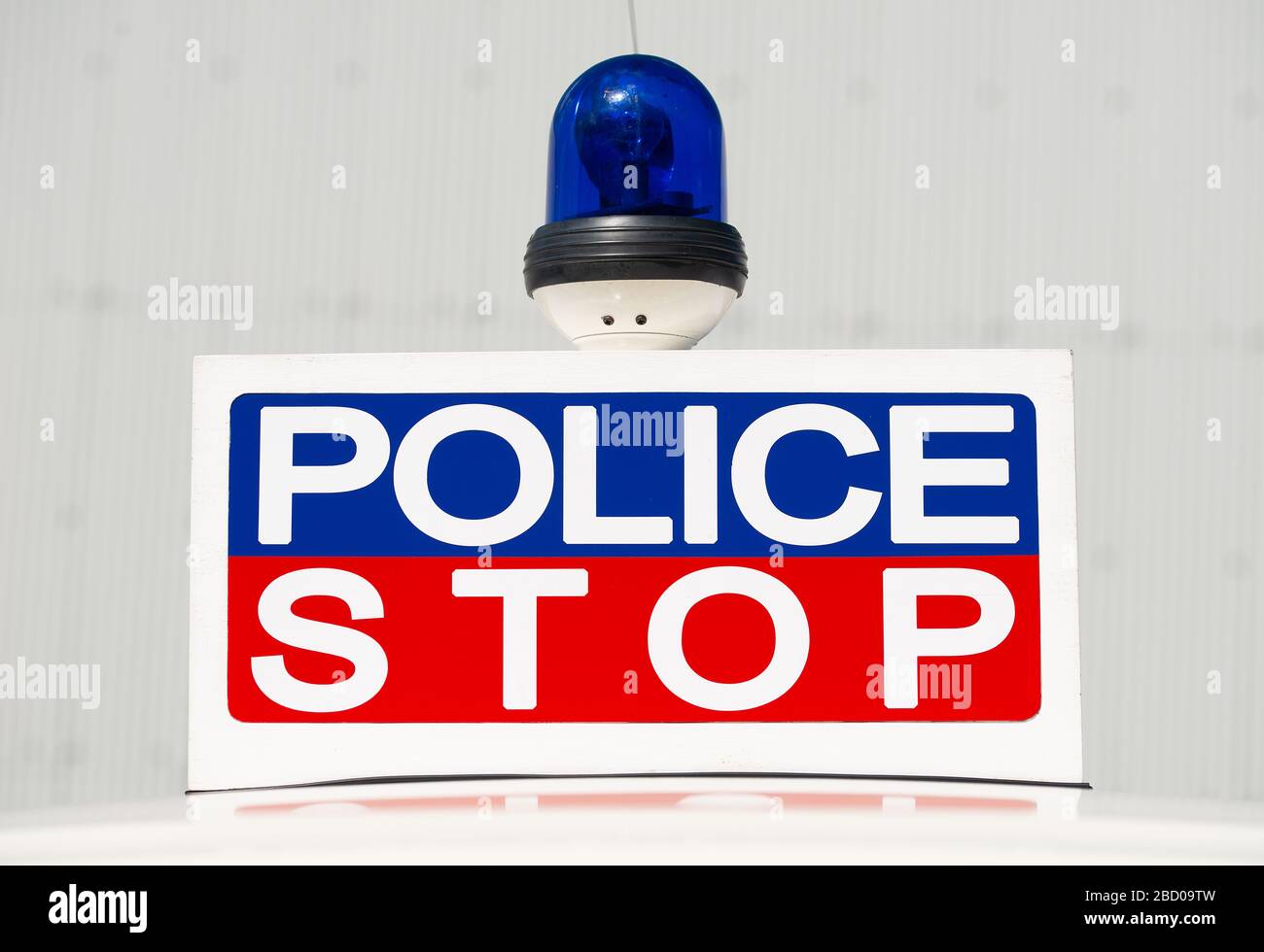 Police sign with blue lights, atop an emergency response patrol vehicle ...