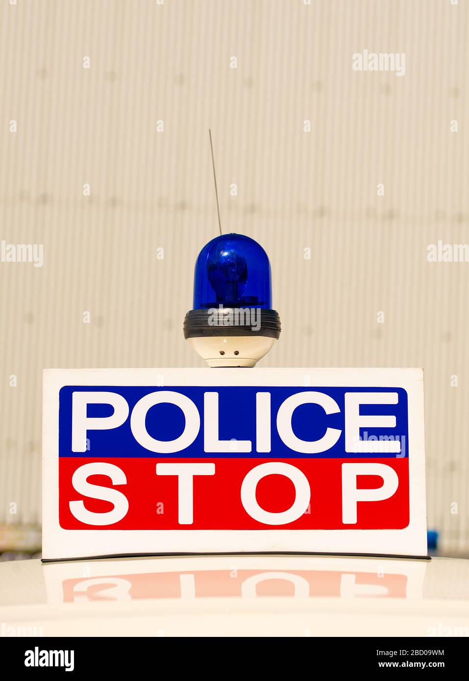Police sign with blue lights, atop an emergency response patrol vehicle ...