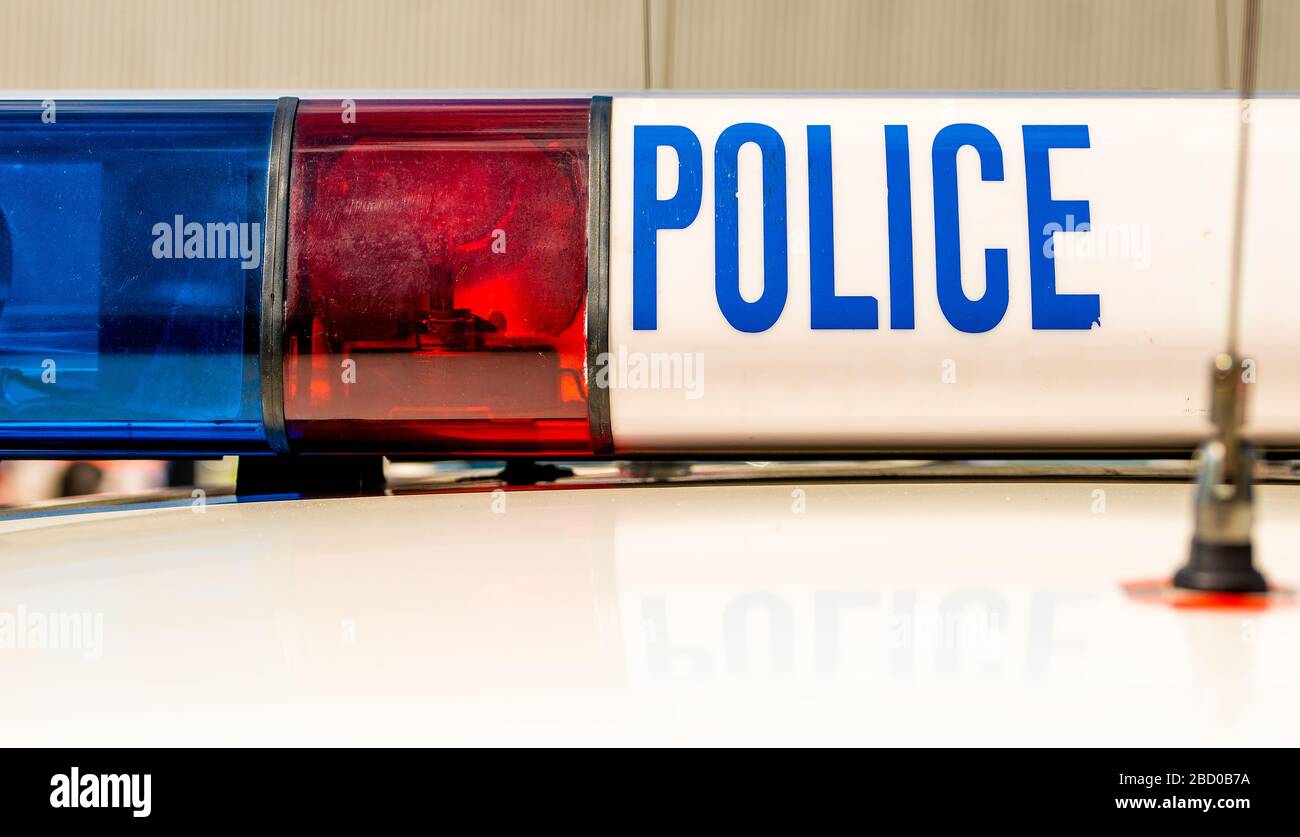 Police sign with blue lights, atop an emergency response patrol vehicle ...