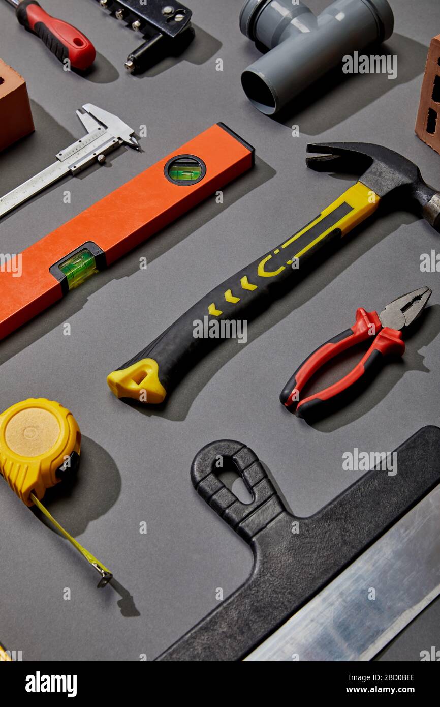 flat lay with measuring tape, calipers, hammer, screwdriver, brush ...
