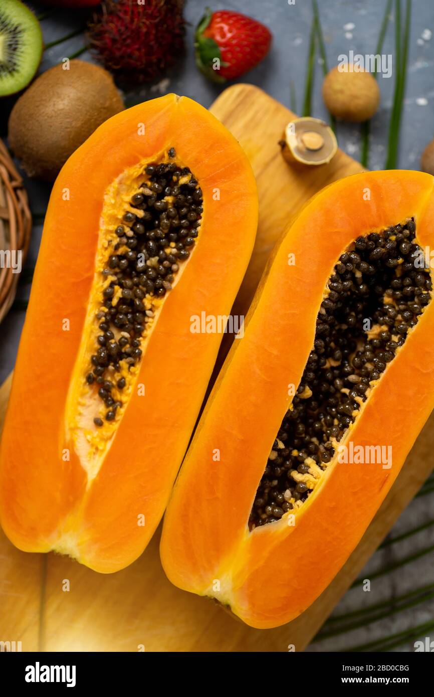Papaya. Tropical Fruits. Close up shot of two halves of ripe papaya ...