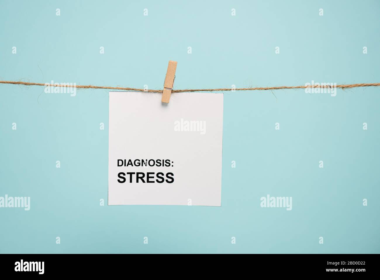 Card with diagnosis stress lettering on rope with pin isolated on blue ...