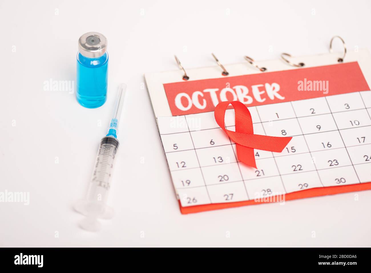 Selective focus of calendar with october month, aids awareness red ...
