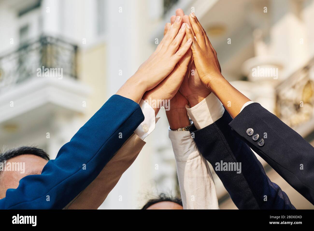 Group of successful business people giving high five together Stock ...