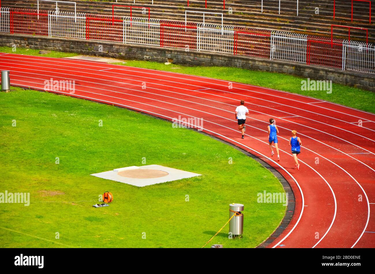 Group of athletes run on the track during race Stock Photo - Alamy