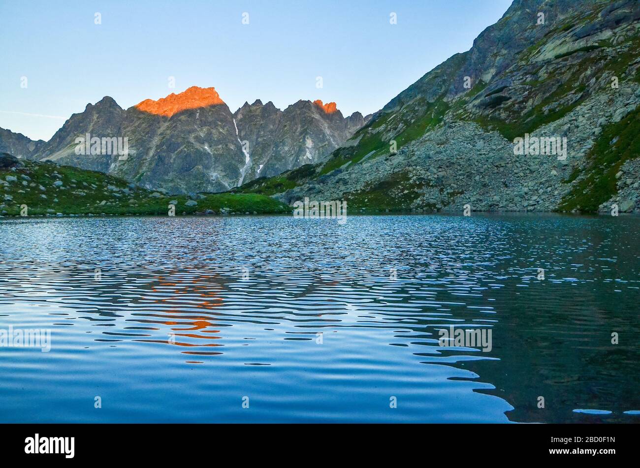 Panorama photo of sunrise light on mountains ridge with mirroring in ...