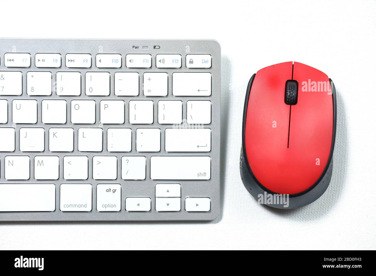 red mouse and white keyboard isolated on a white background ...