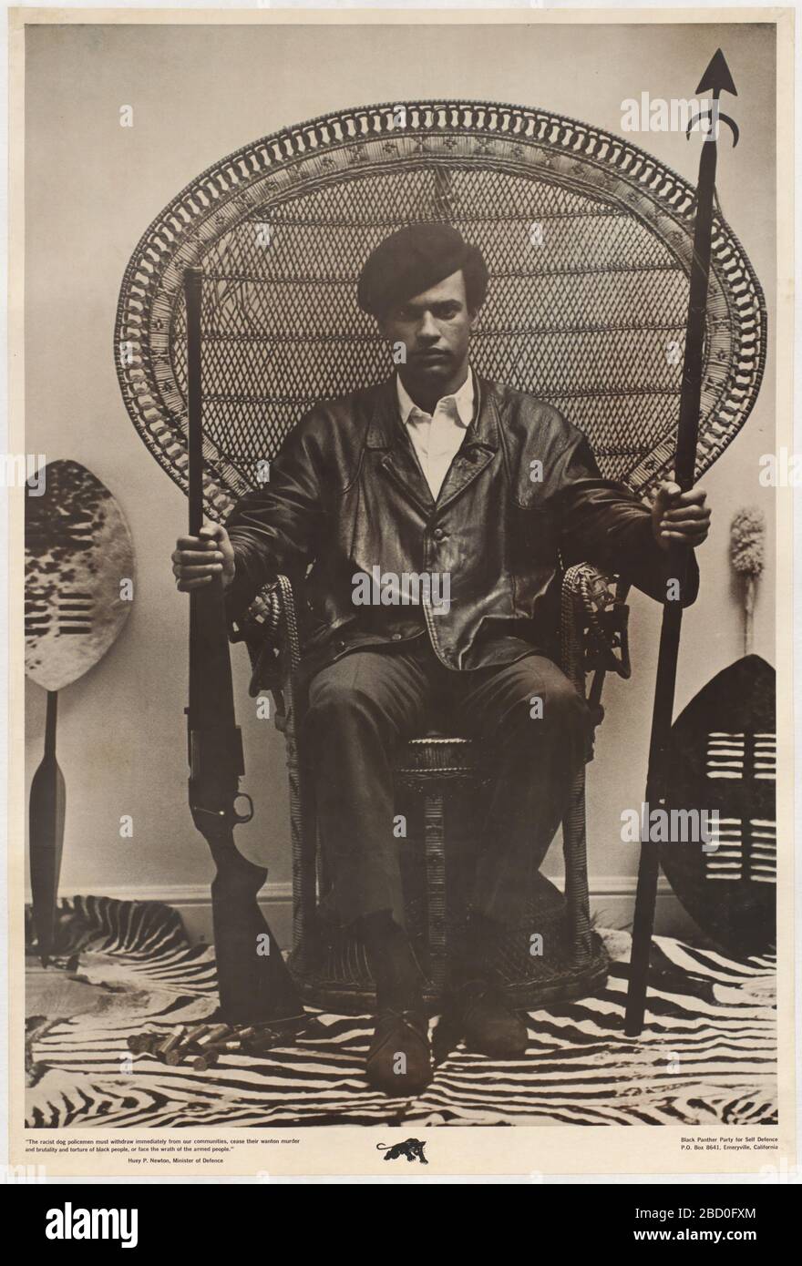 Huey Newton Black Panther Minister of Defense. A poster of Huey Newton sitting in a rattan throne chair wearing a beret and a black leather jacket while holding a rifle in his