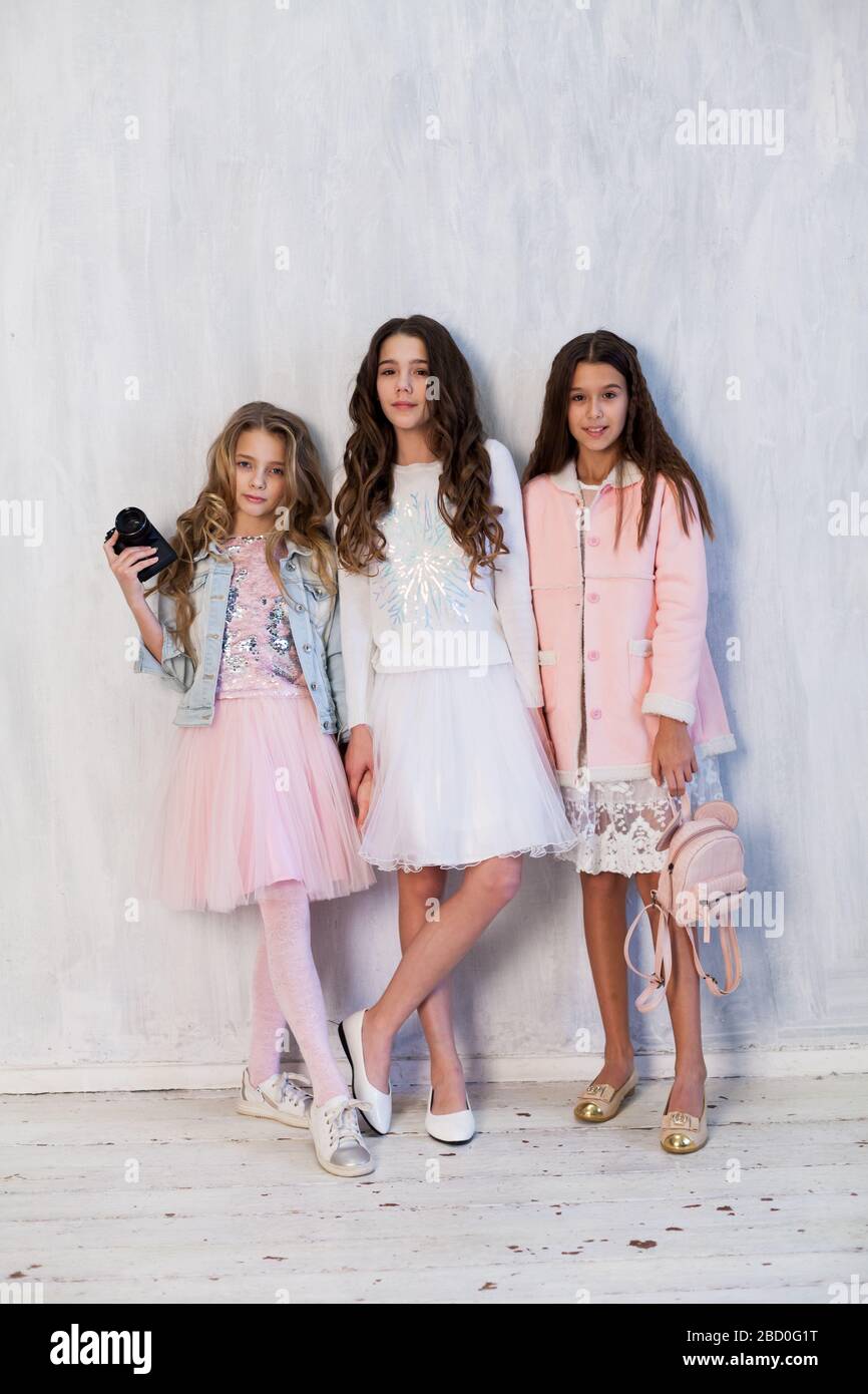 Three beautiful girls with a camera at a photo shoot Stock Photo - Alamy