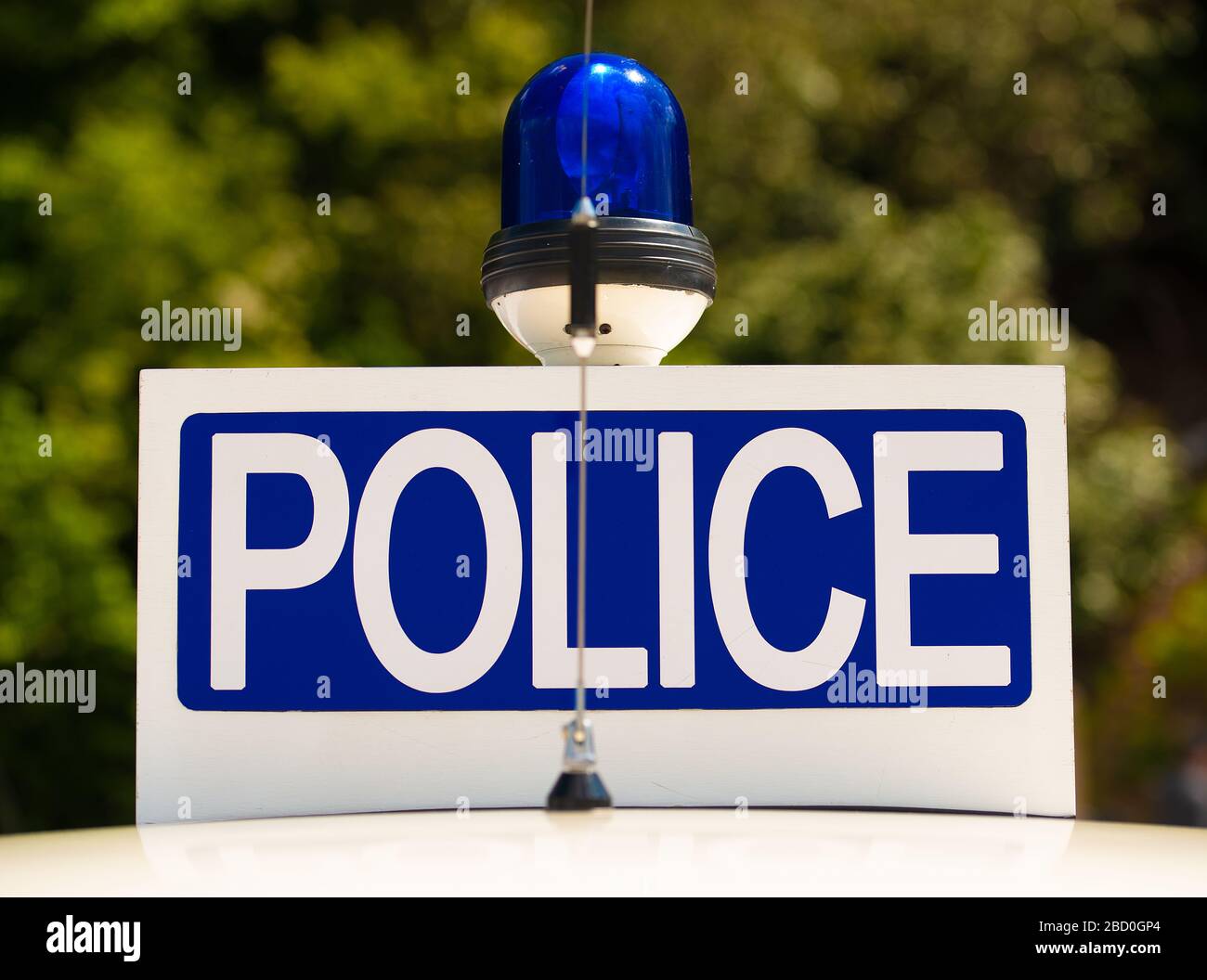 Police sign with blue lights, atop an emergency response patrol vehicle ...