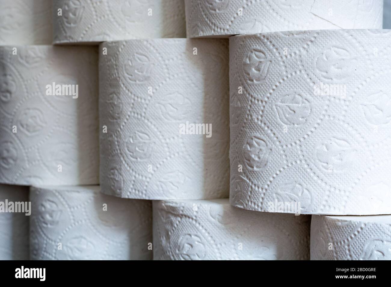 Piled up toilet paper rolls as a close up from the side Stock Photo - Alamy