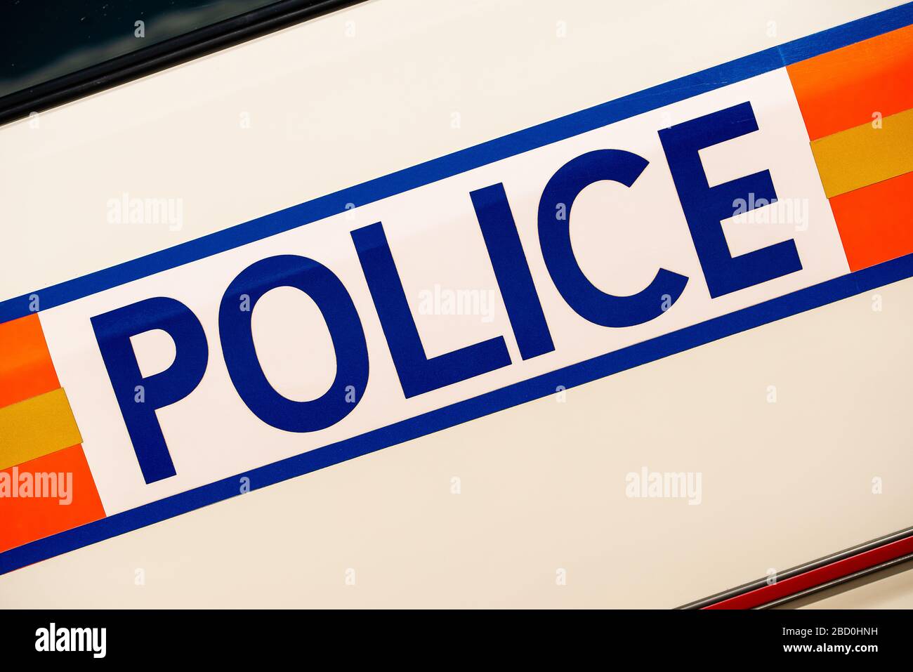 Angled view of large POLICE sign on the side door of an emergency ...