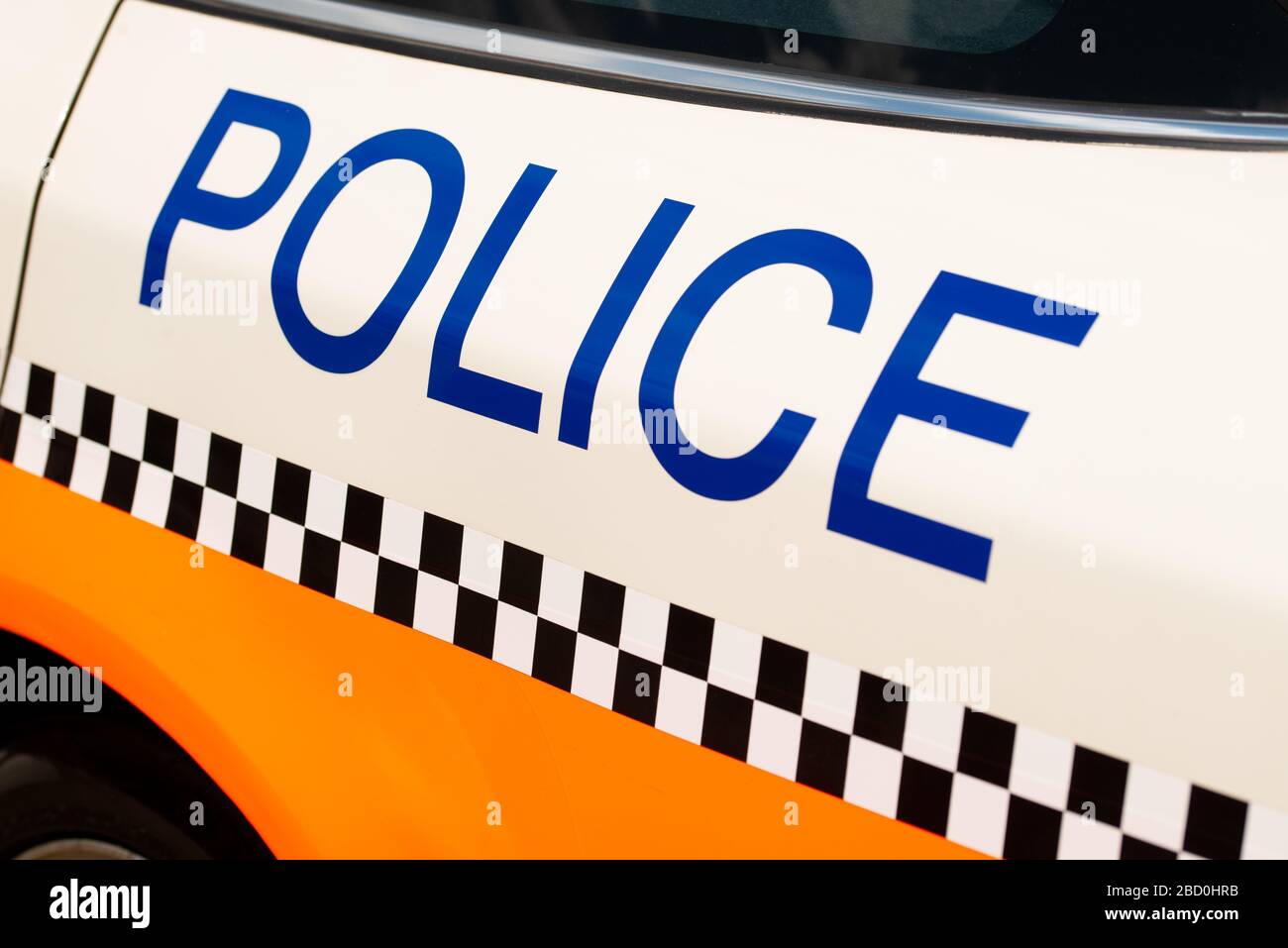 Angled view of large POLICE sign on the side door of an emergency ...
