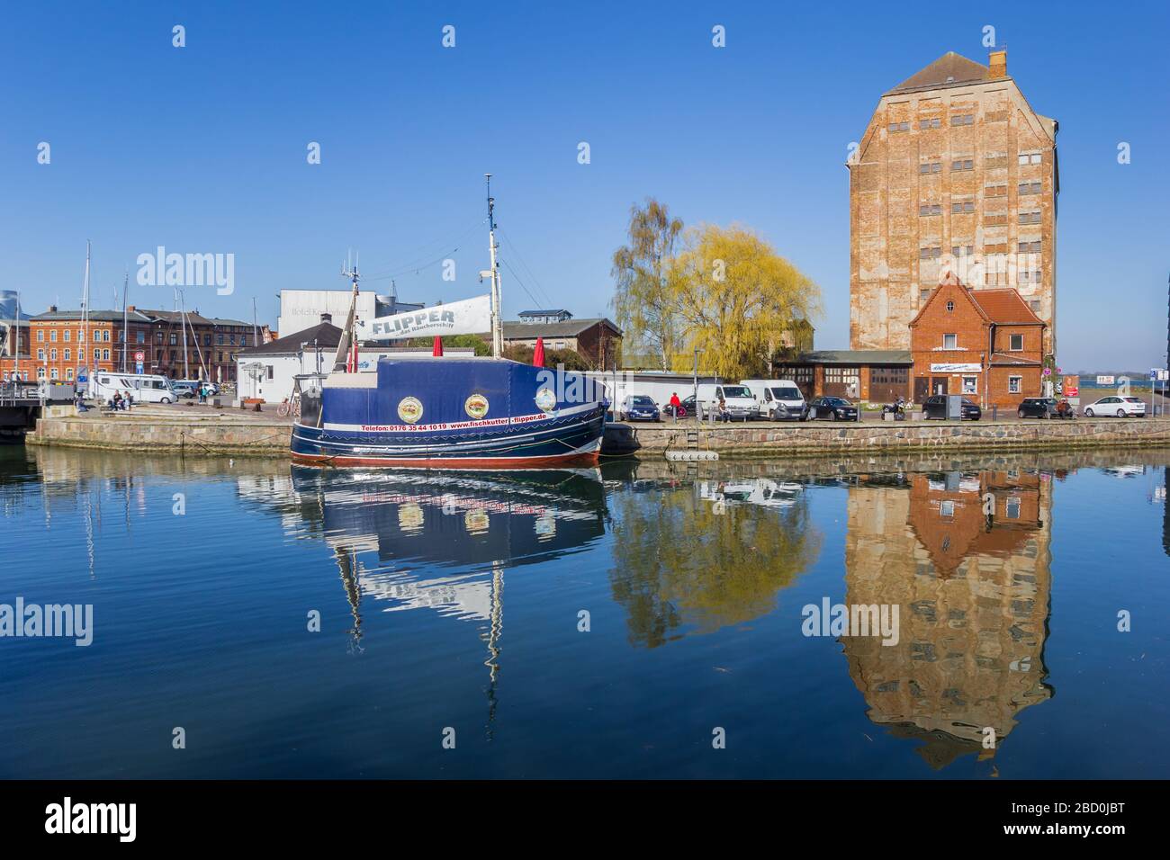 Old boat and warehouse in the harbor of Stralsund, Germany Stock Photo ...
