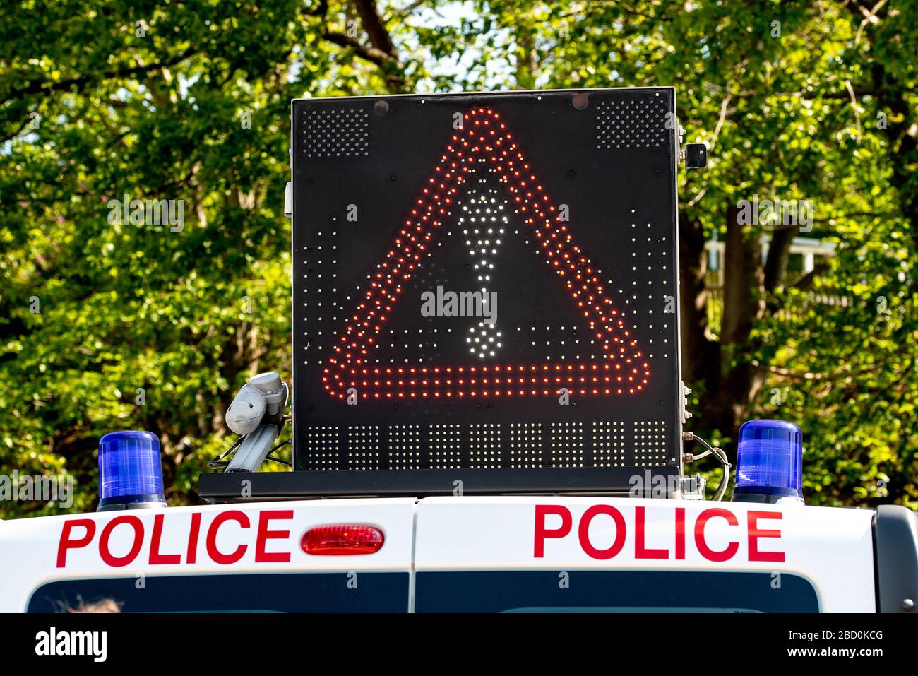 View of police caution sign with blue lights atop of a emergency ...