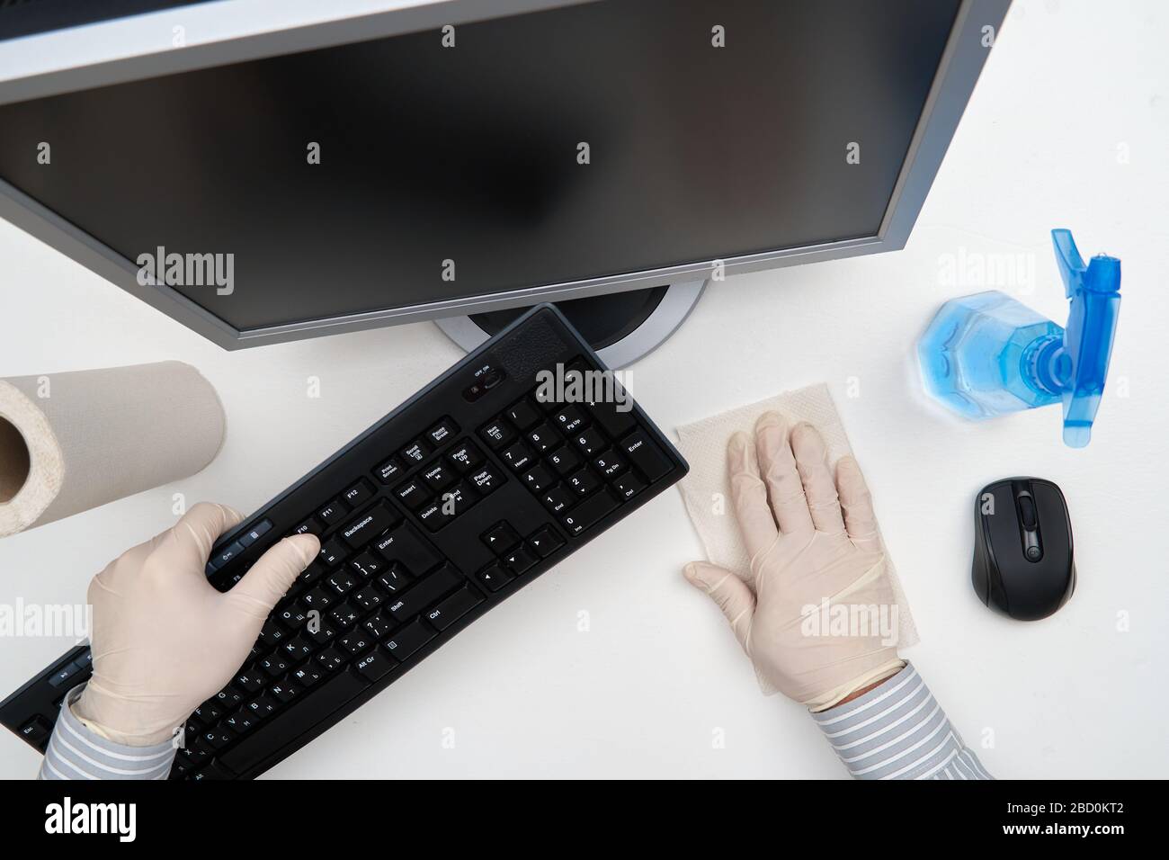 concept of cleaning or disinfecting the office - a businessman cleans ...