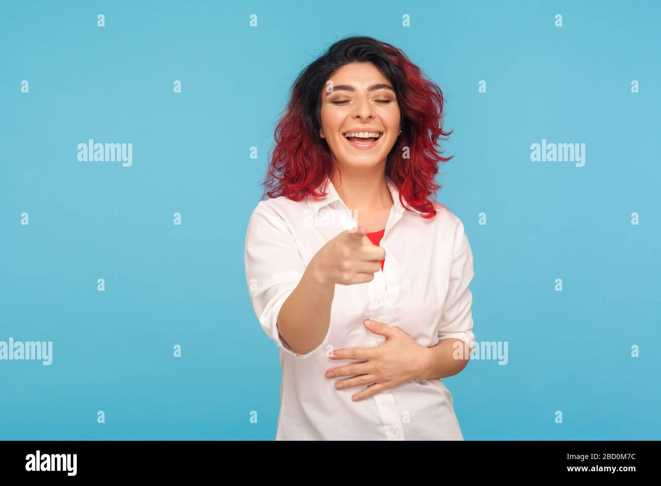 Hilarious laughter. Portrait of joyful hipster woman with fancy red ...