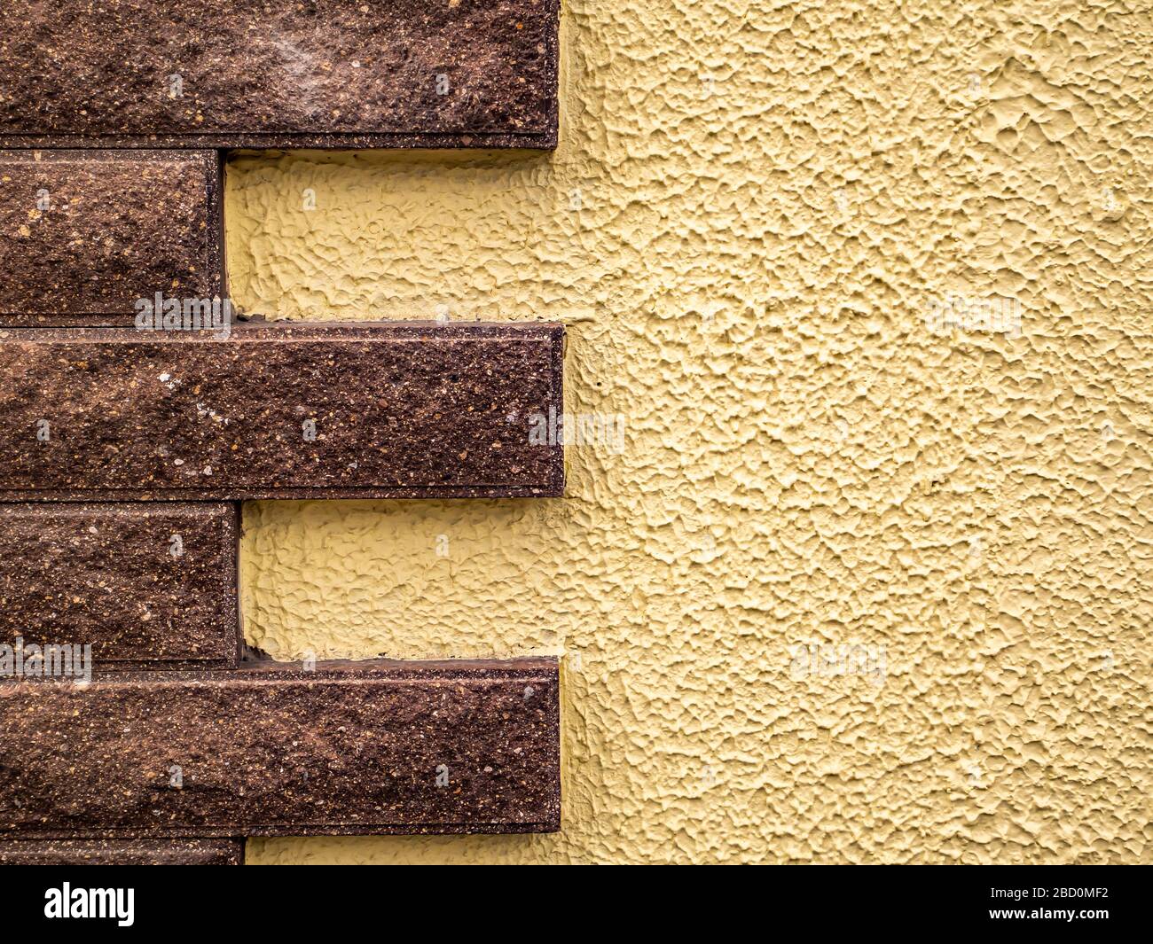 Wall with ceramic tiles in the form of stone bricks Stock Photo - Alamy
