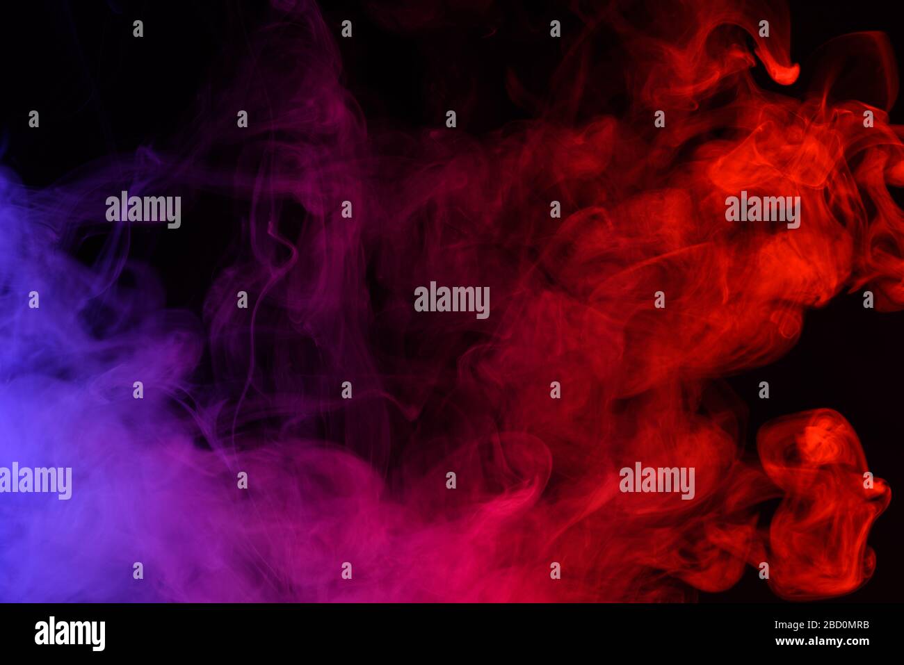 Colored smoke clouds flowing dark abstract background Stock Photo - Alamy