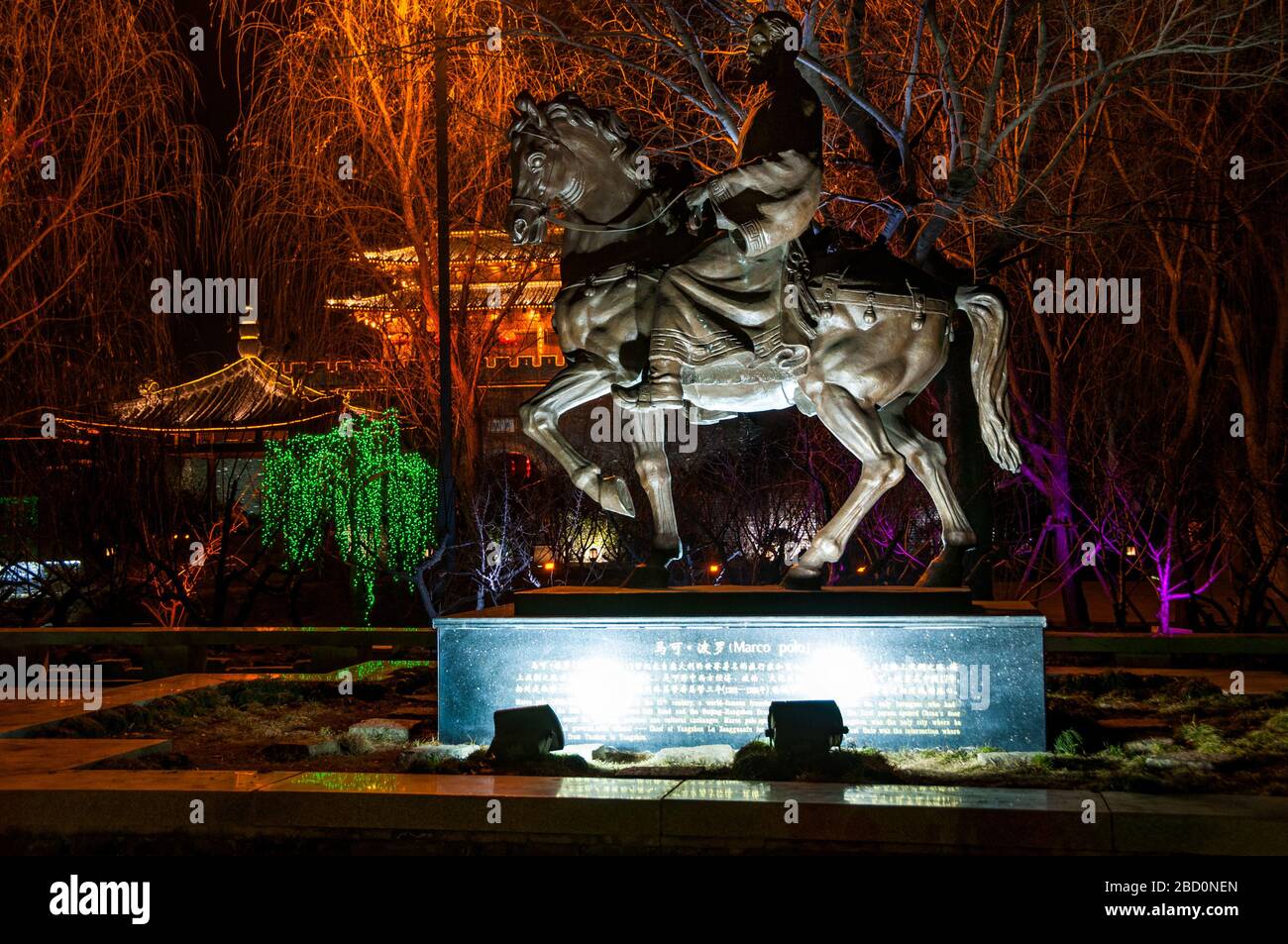 Statue of Marco Polo on a horse in front of Dongmen in the evening. It ...