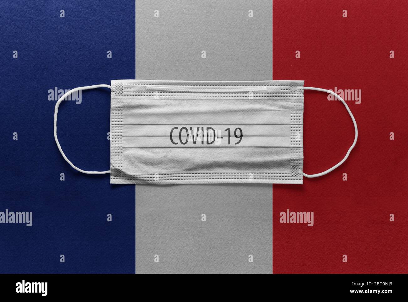An individual face medical surgical mask on France flag Background ...
