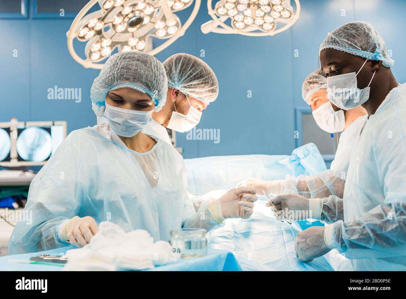 An international team of doctors performs a complex surgical operation ...