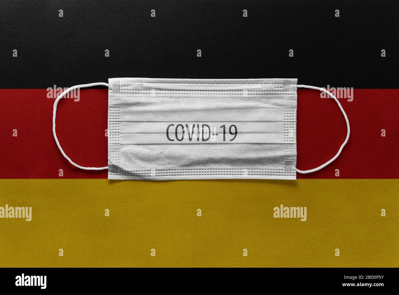 An individual face medical surgical mask on Germany flag Background ...