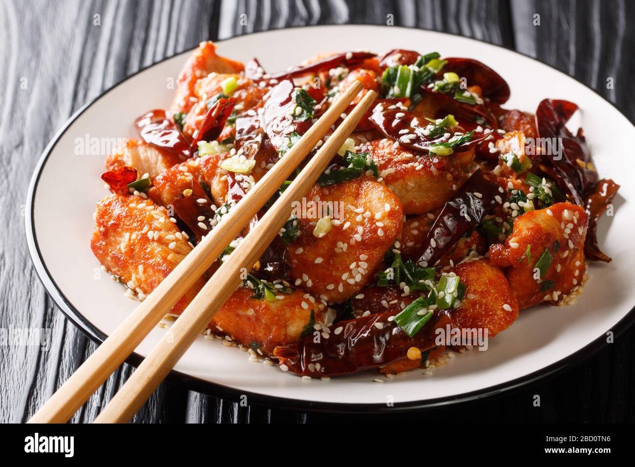 Chinese mala chicken with lots of sichuan pepper closeup in a plate on ...