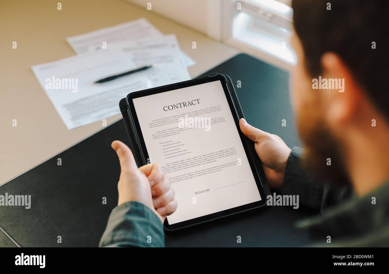 Lawyer reading contract template on tablet and showing thumbs up Stock ...
