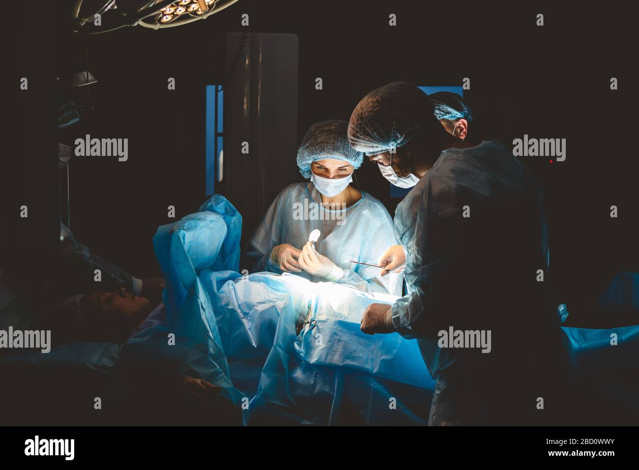 An international team of doctors performs a complex surgical operation ...