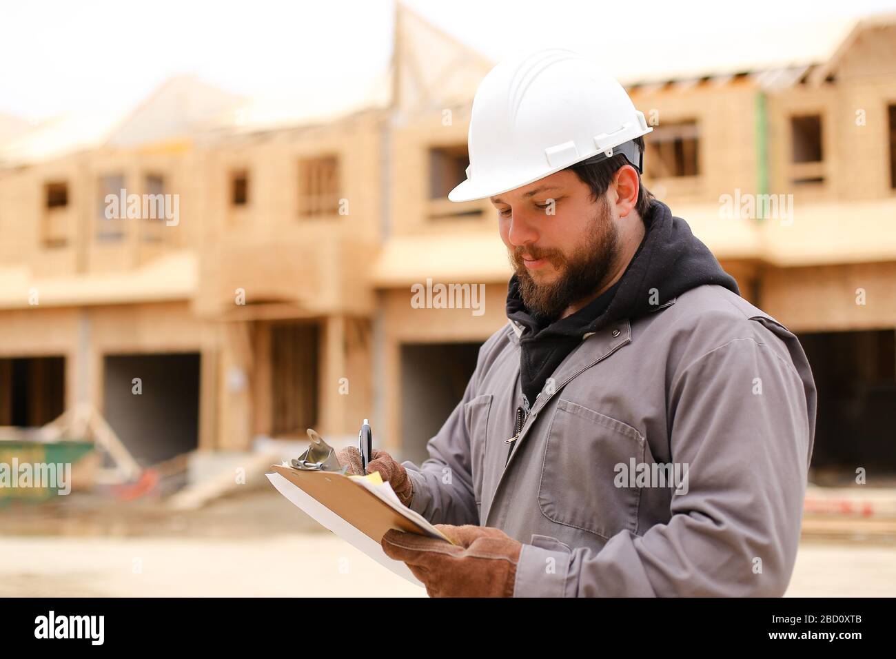 Caucasian engineer drawing plan in notebook at construction site Stock ...