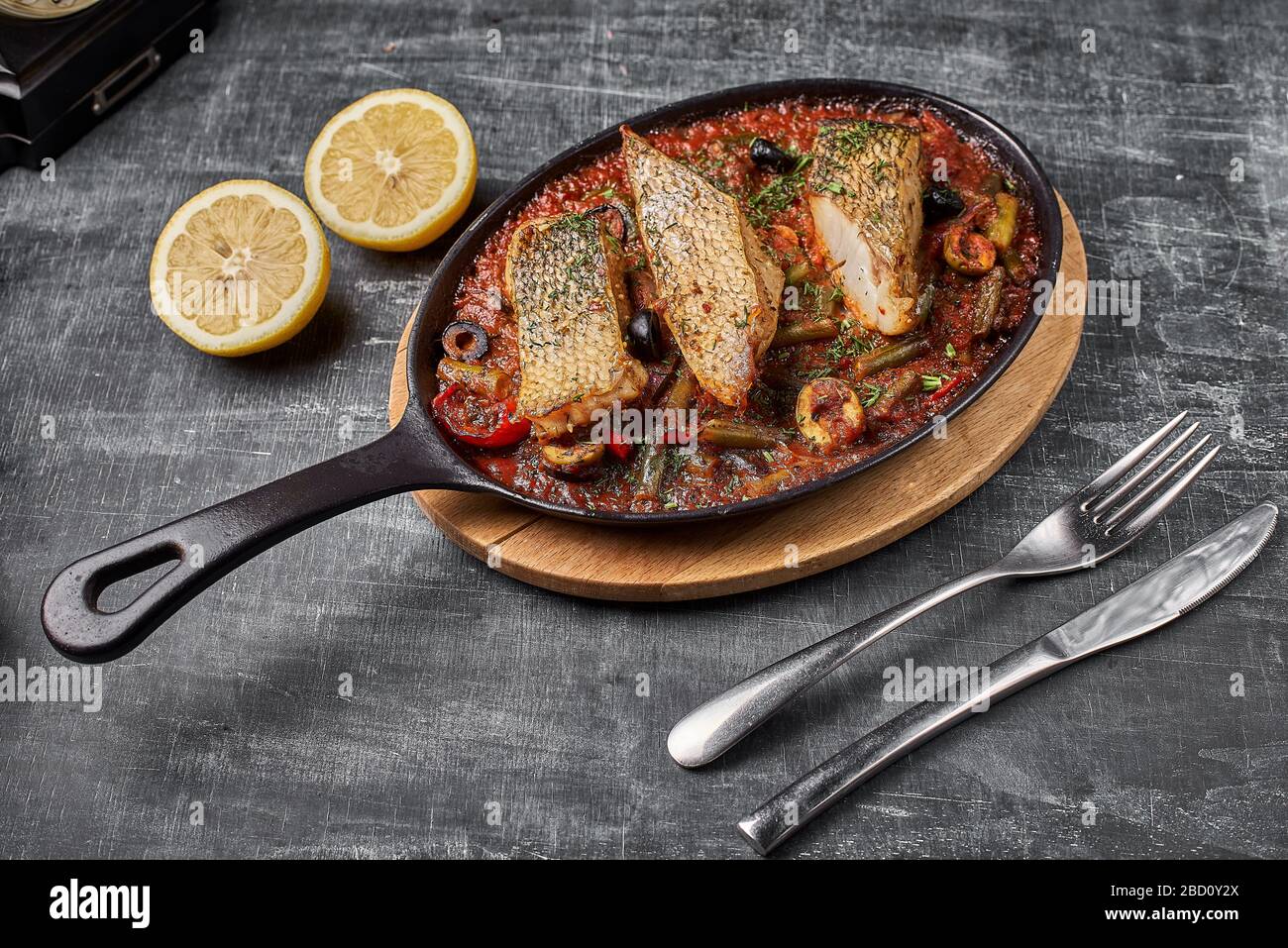Stewed perch in tomato sauce, serve food in the Provencal style, in a ...