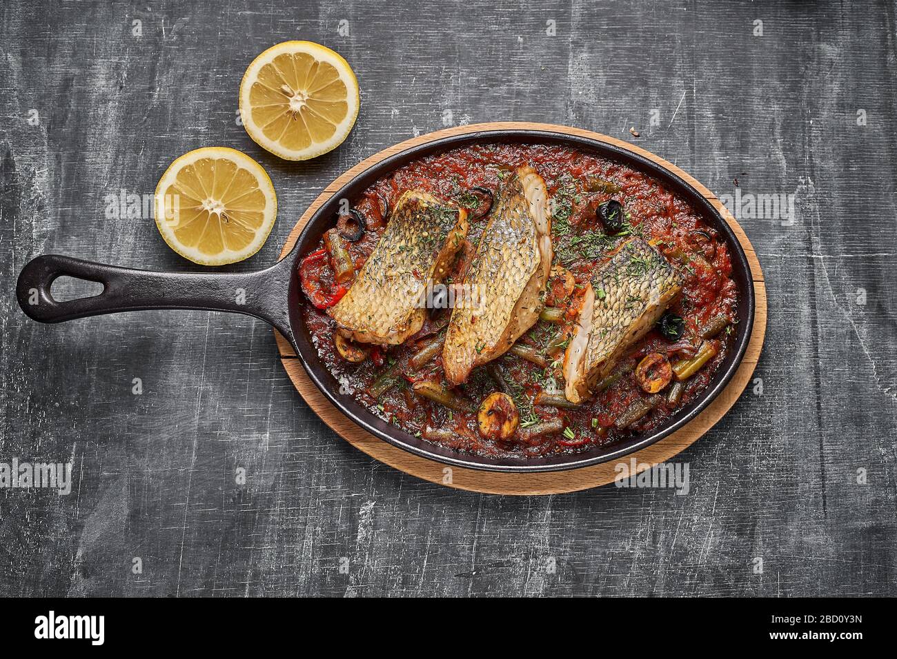 Stewed perch in tomato sauce, serve food in the Provencal style, in a ...