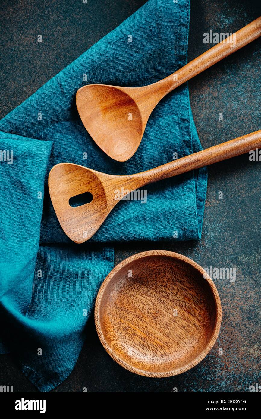 Cooking table background. Wooden kitchen tools and bowl with blue linen ...