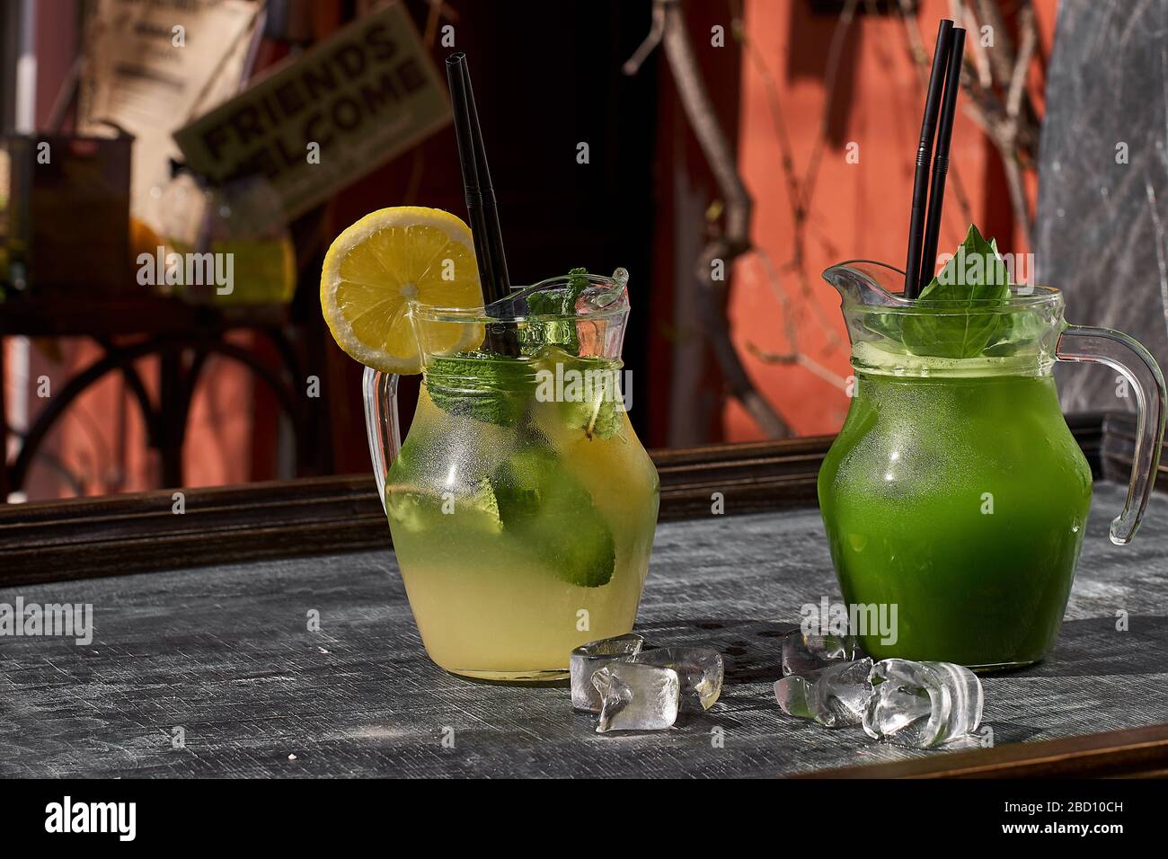 Lemonade with cucumbers, lemons and mint leafs in glasses on wooden table Stock Photo - Alamy