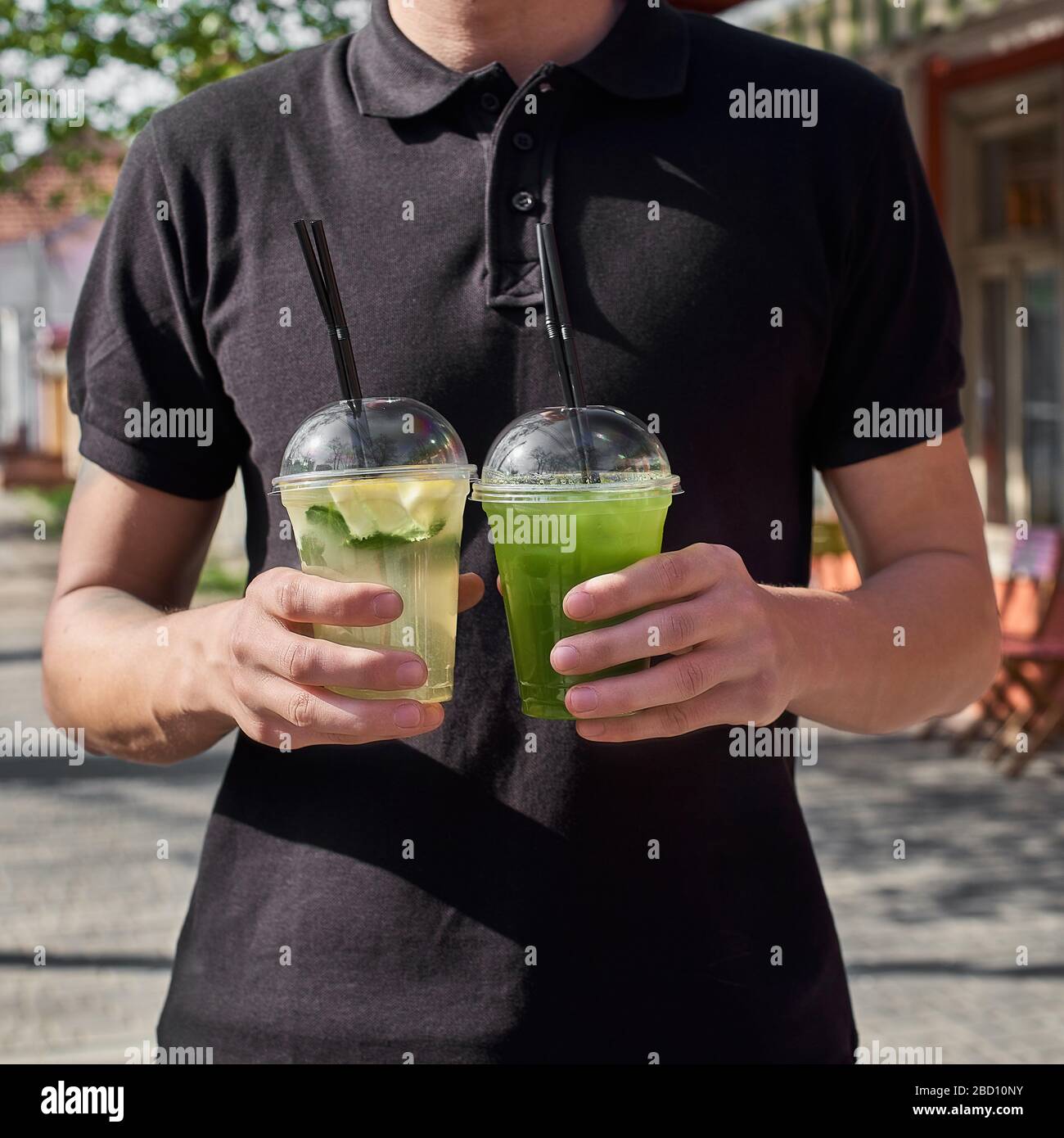 Two lemonade in the hands of the man. fresh cucumber and lemon drinks ...