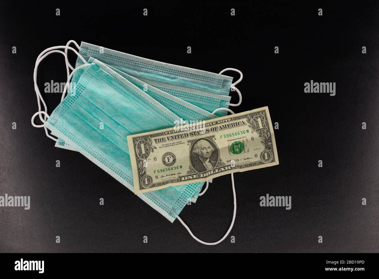Face masks and banknotes of 1 dollar on a black background. The concept ...