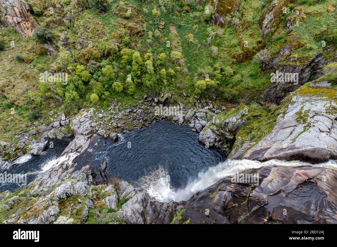 Pozo de los Humos (smoke pit) waterfall in spring forest at Salamanca ...