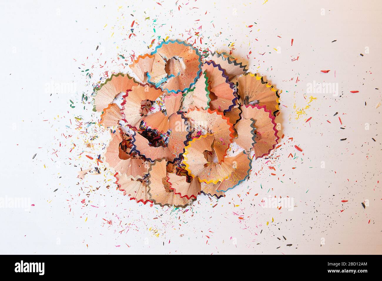 Colored scraps of tempered pencil on a white background. Colored ...