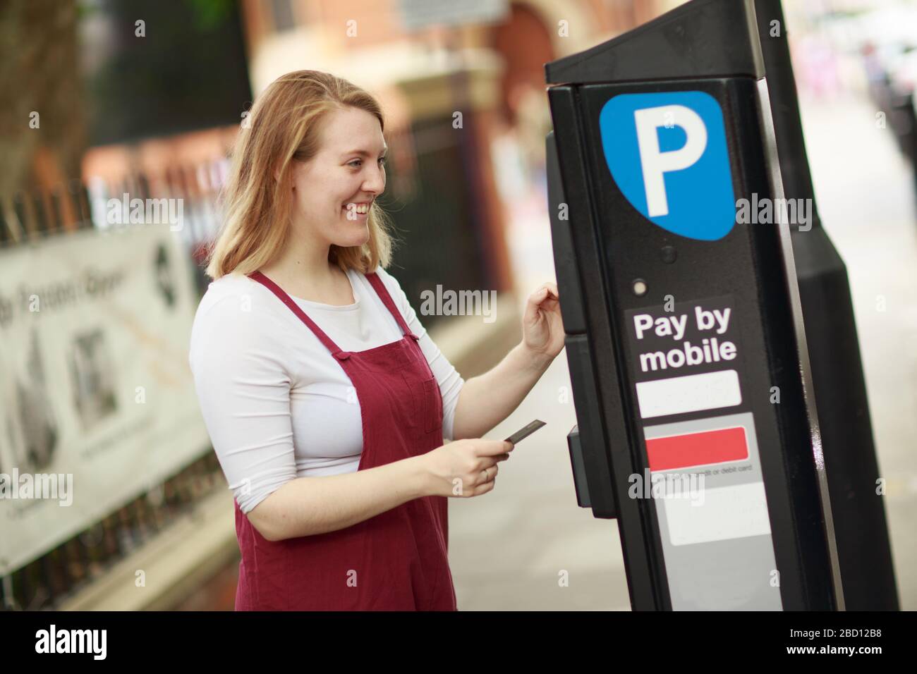 young woman paying a parking fee Stock Photo - Alamy