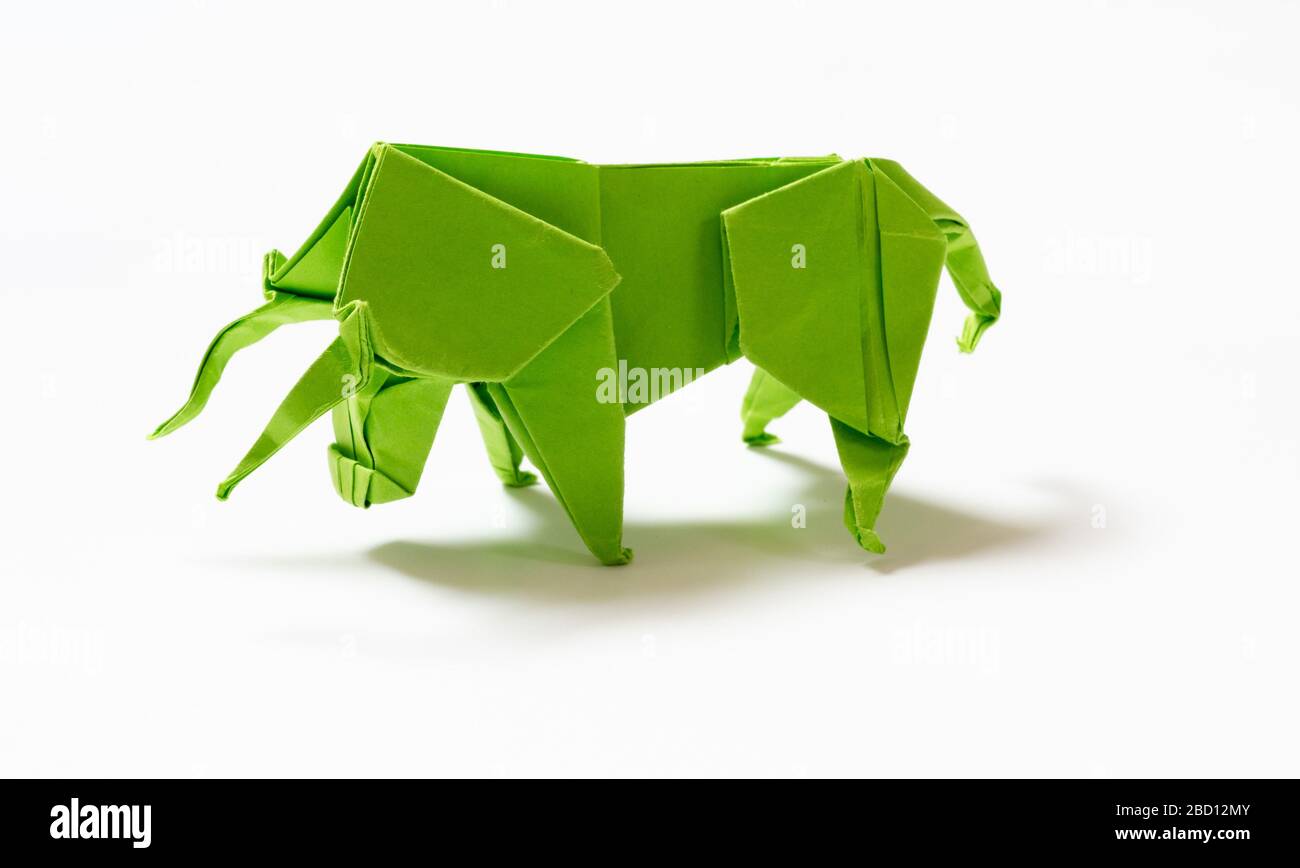 An powerful green Origami paper bull as clipping from the side Stock ...