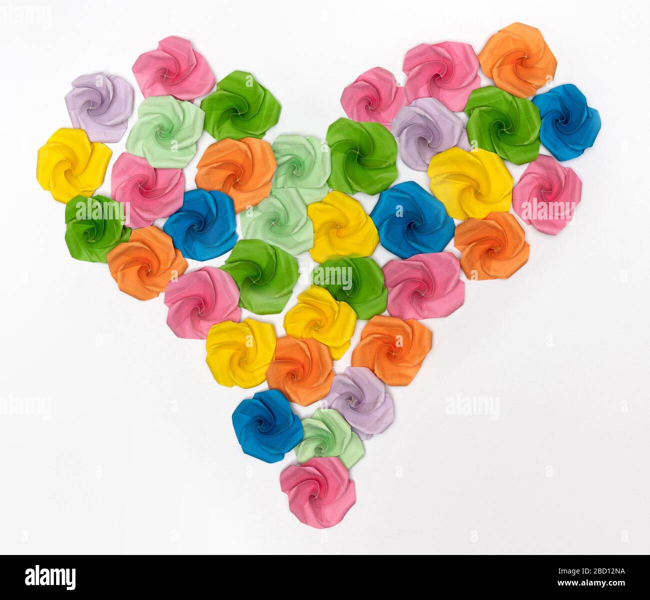 A heart of colorful origami paper flowers on a white background Stock ...