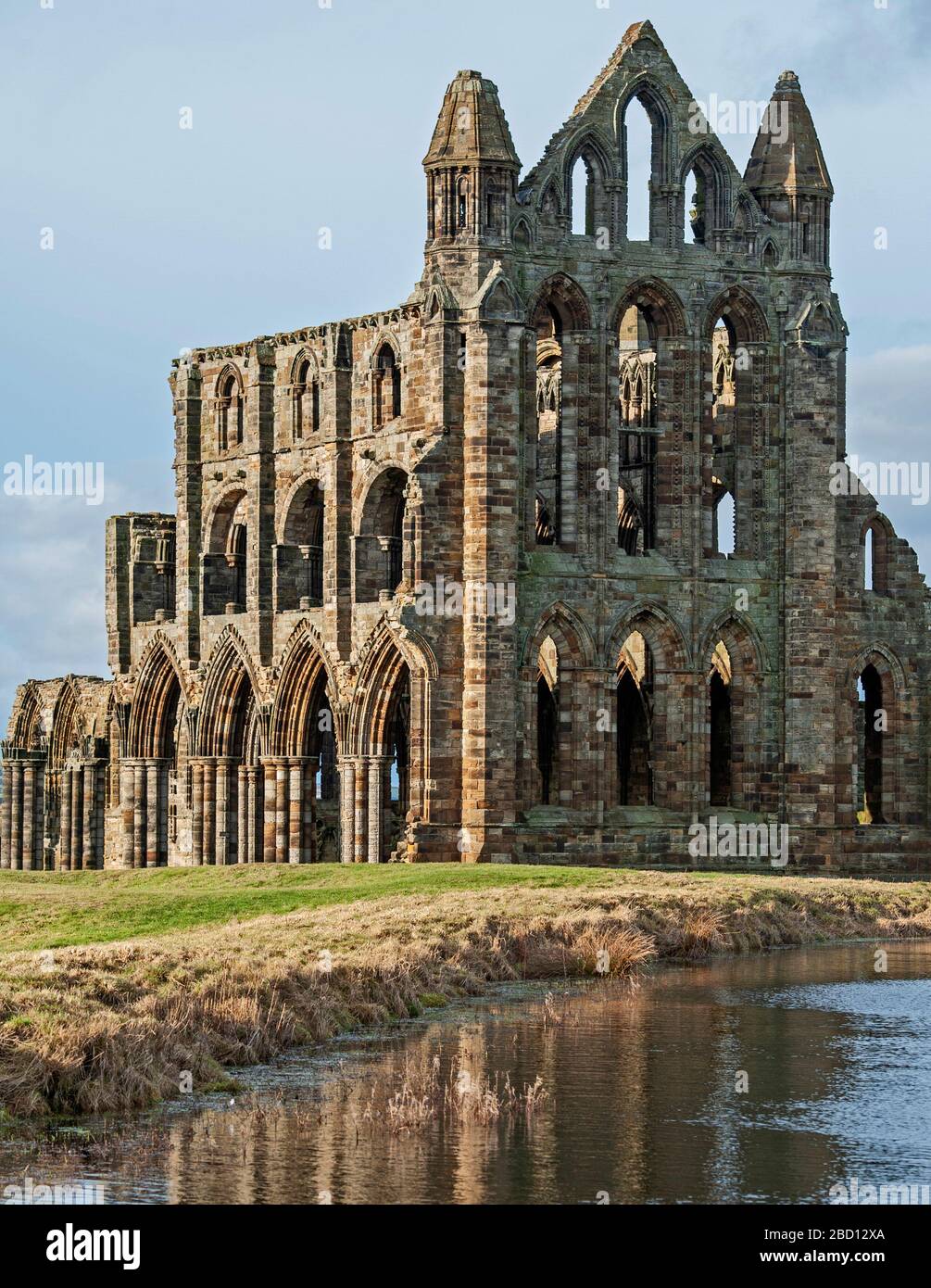 Remains of an ancient gothic english abbey ruins with reflection in ...