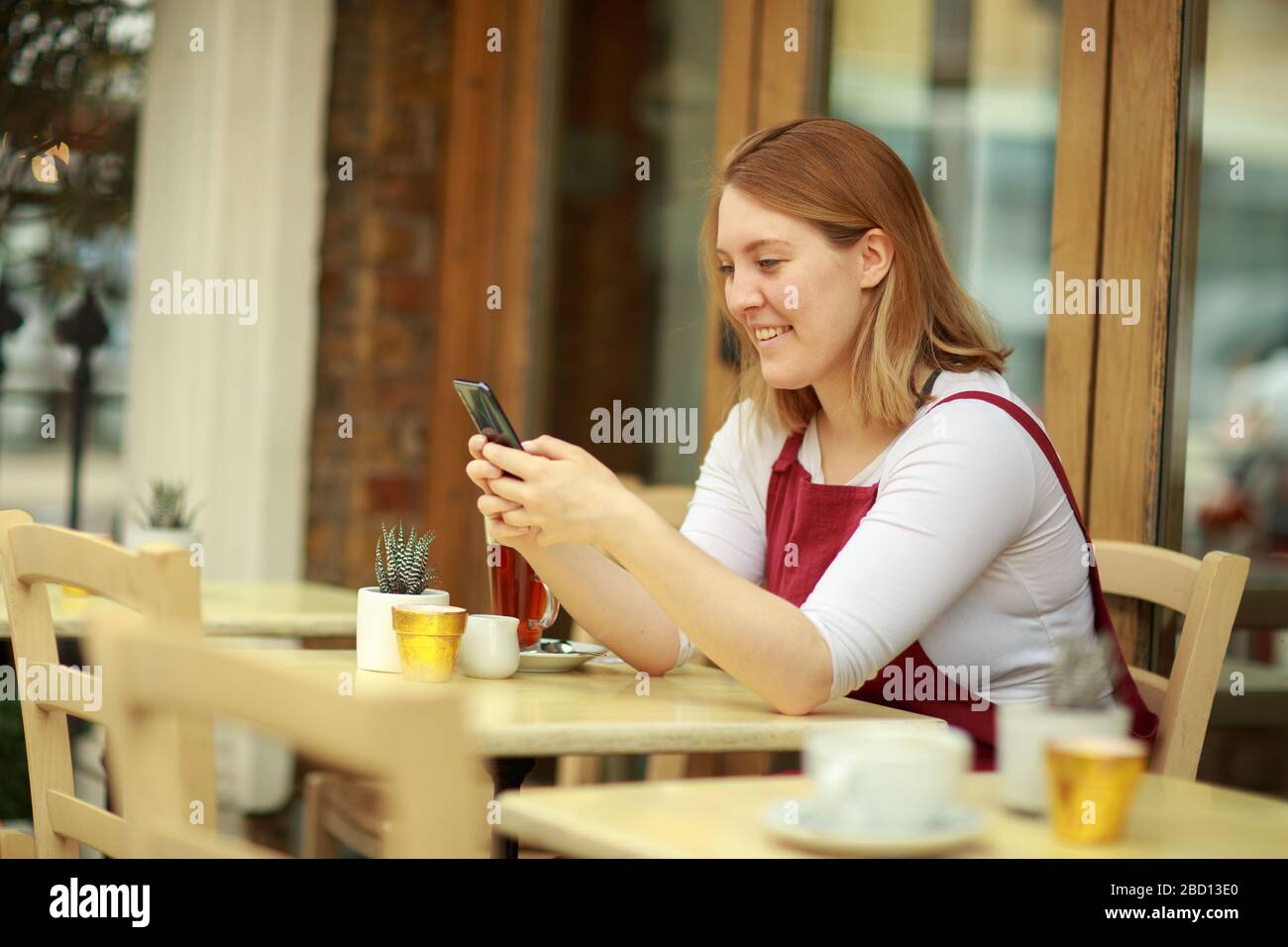 young woman sending a text message Stock Photo - Alamy
