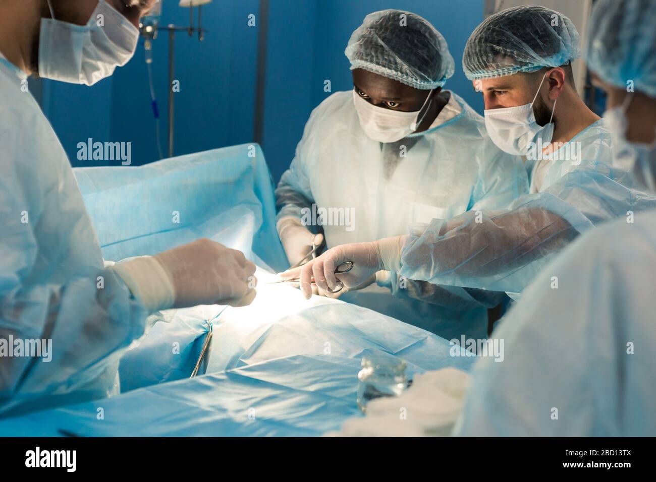 An international team of doctors performs a complex surgical operation ...