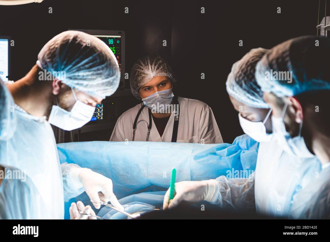 An international team of doctors performs a complex surgical operation ...